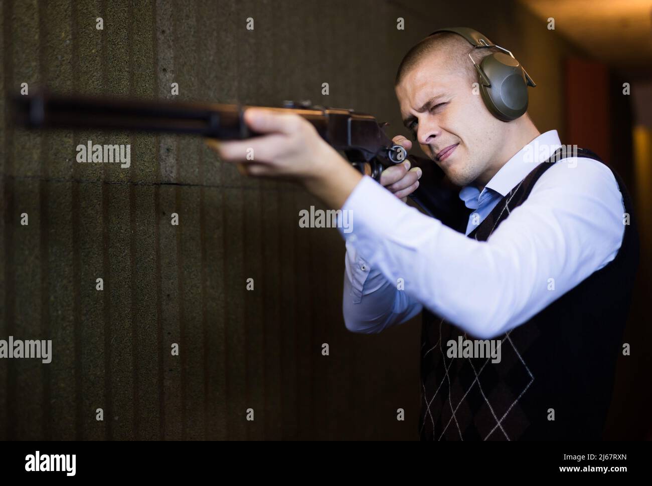 Man aims at a target with a double-barreled gun in shooting range Stock ...
