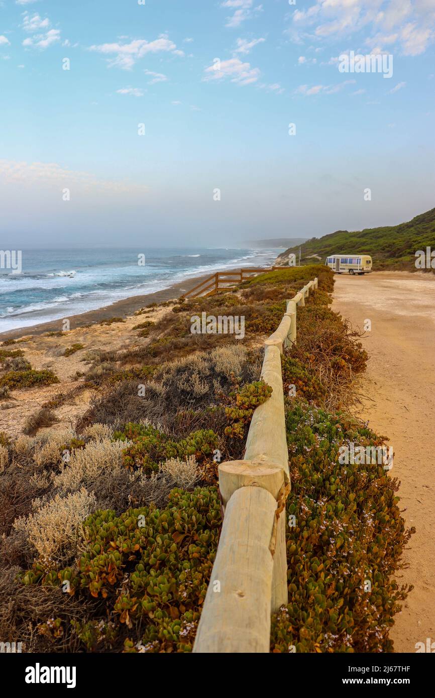 A peaceful beach scene with a campervan in the background Stock Photo ...
