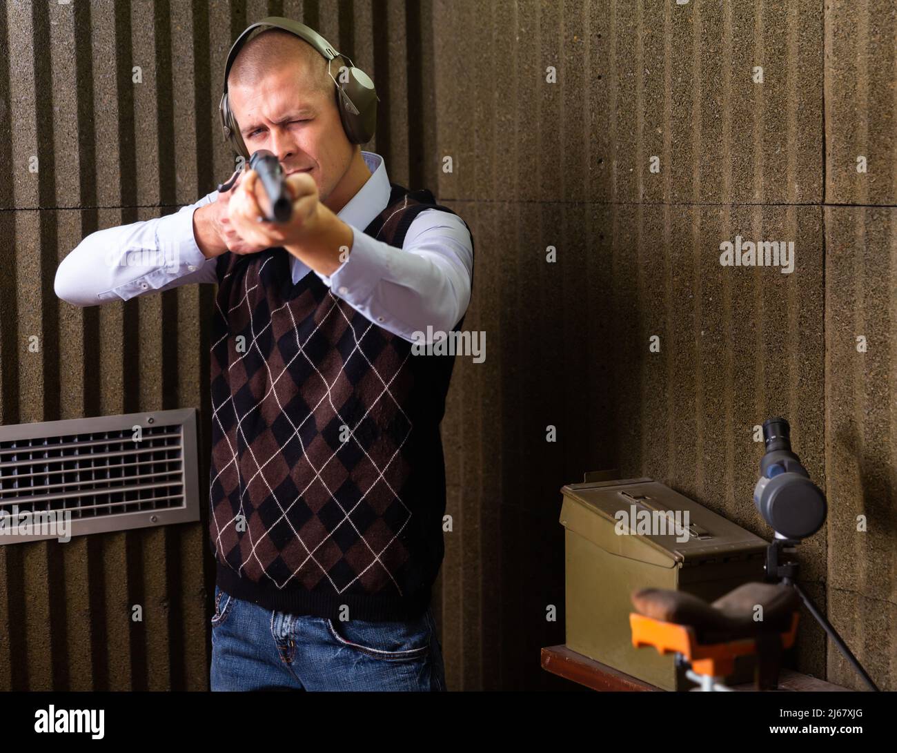 Concentrated man practicing shotgun shooting at firing range Stock ...