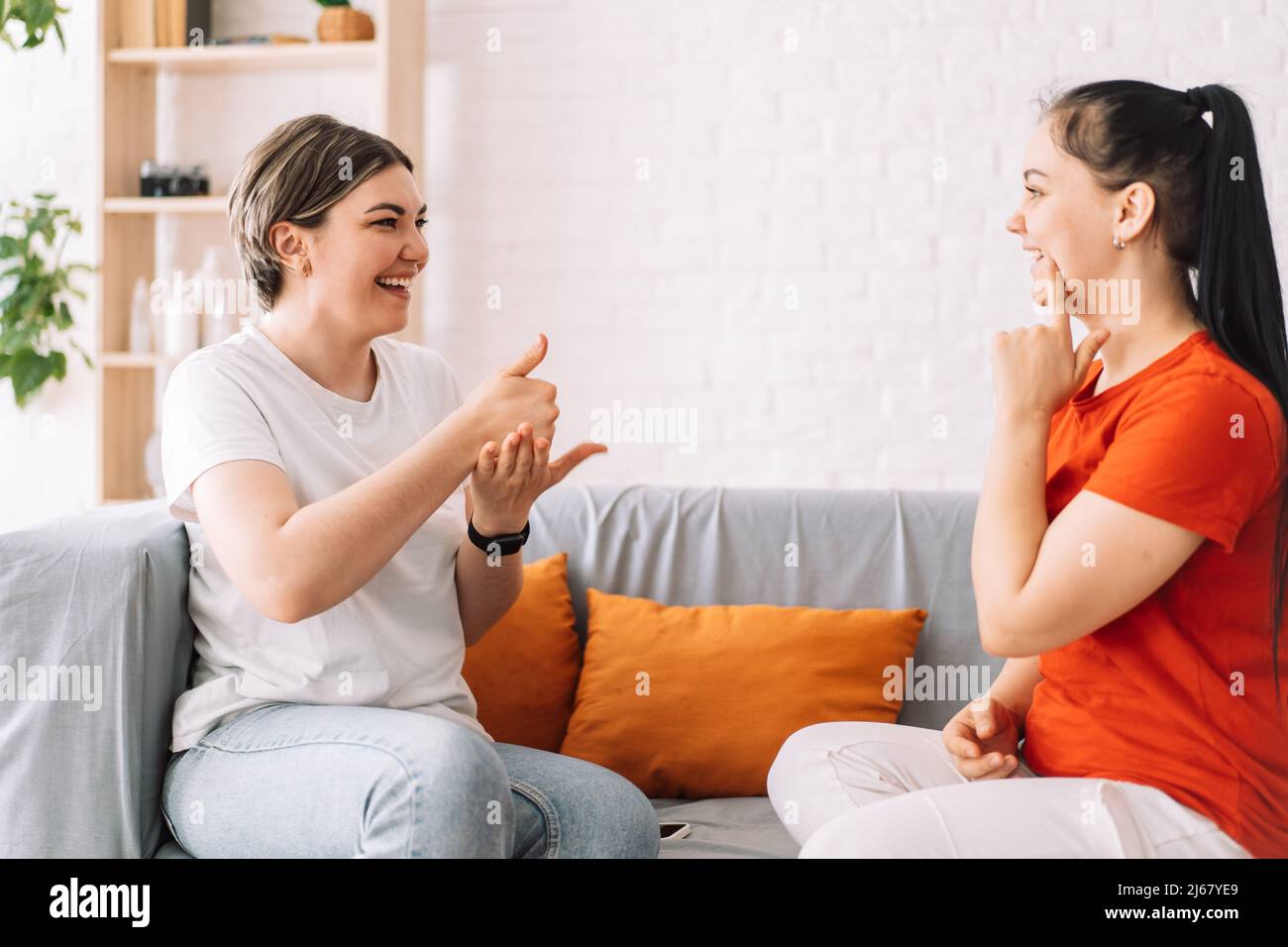 Teacher teaches girl sign language Stock Photo - Alamy