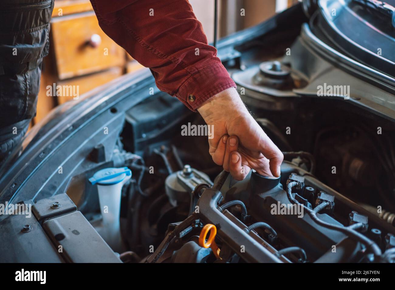 Mechanic checks with his finger for carbon deposits in the engine Stock ...