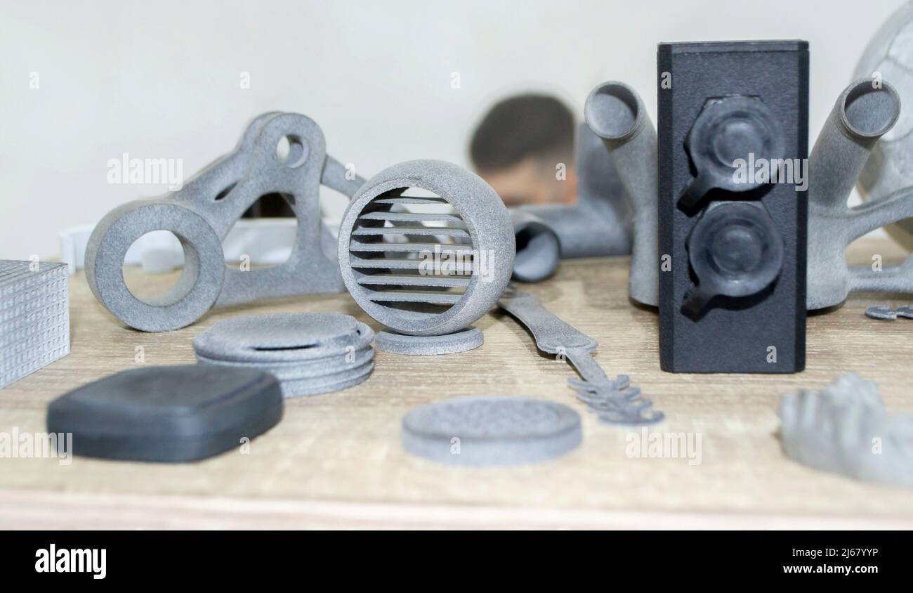 Many models printed on 3D printer. Gray and black objects printed 3D ... Many models printed on 3D printer. Gray and black objects printed 3D ...