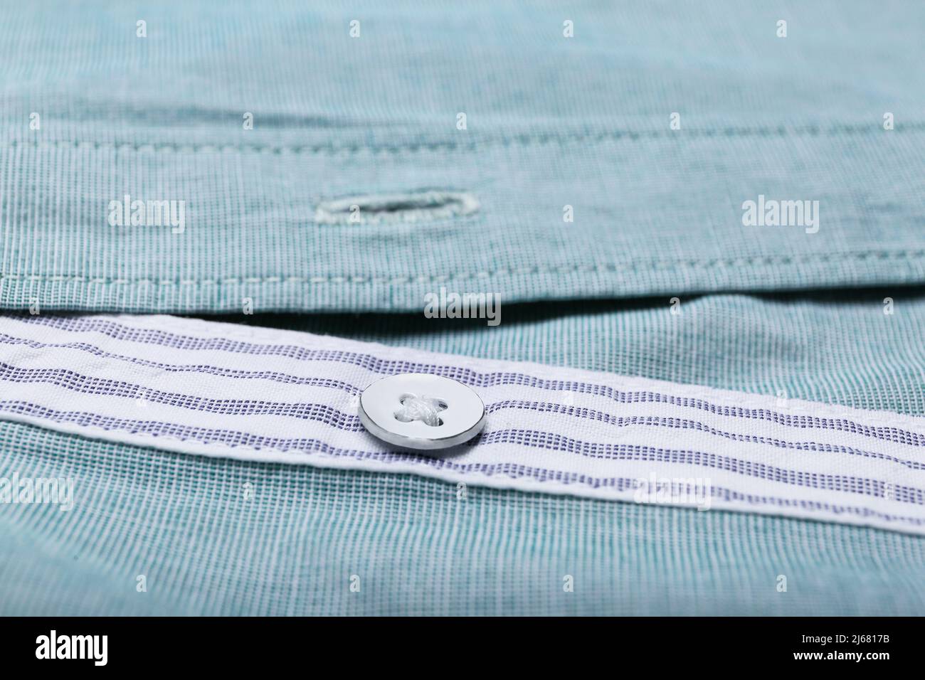 Closeup view of button on male shirt Stock Photo - Alamy