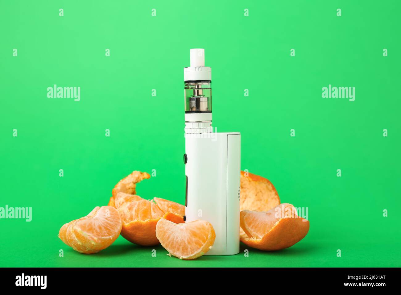 Modern vape mod and mandarin on green background Stock Photo - Alamy