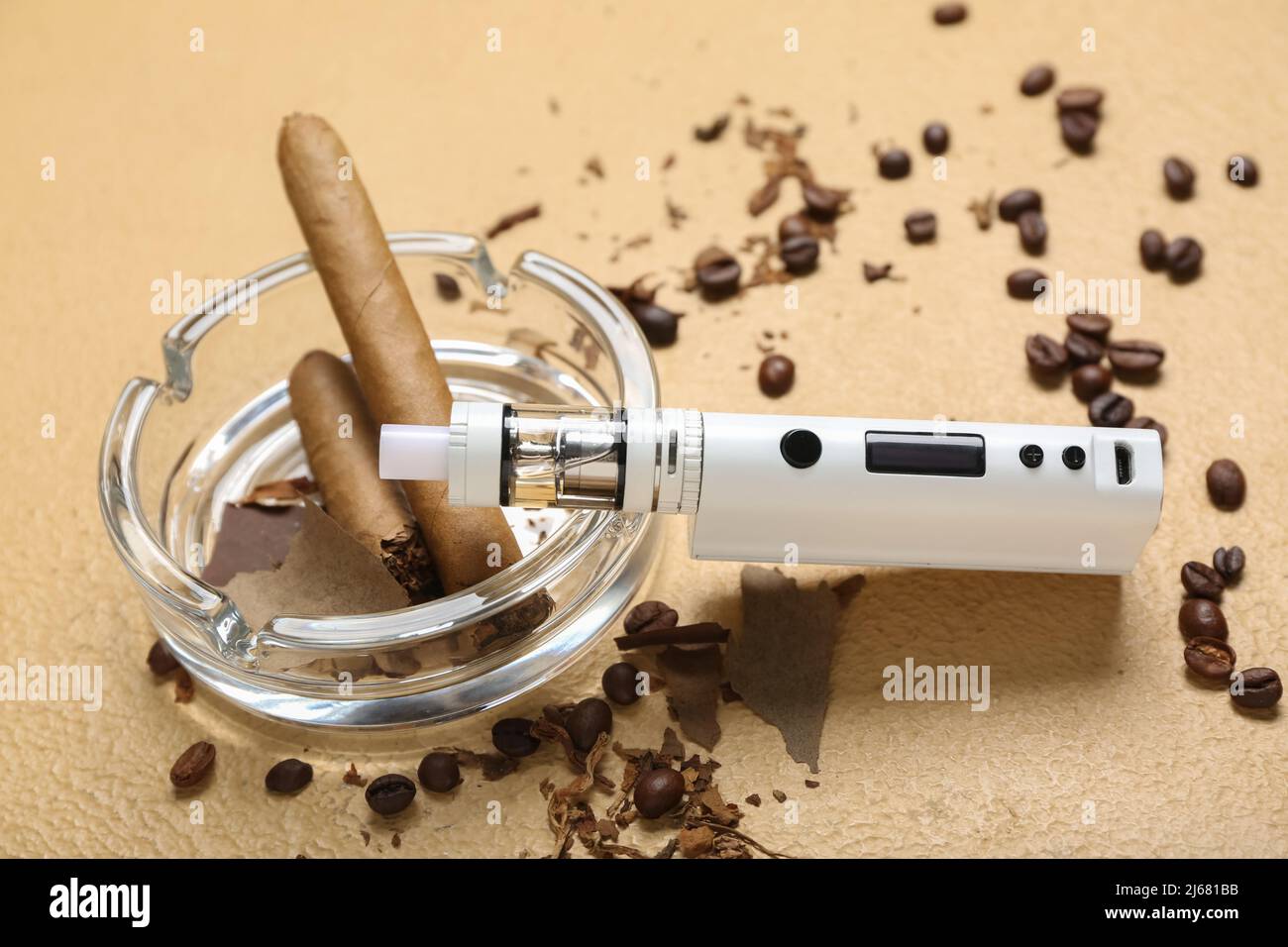 Modern vape mod, cigars and coffee beans on beige background, closeup ...