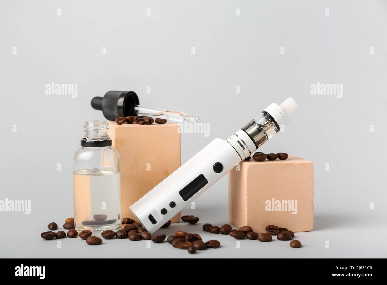 Modern vape mod, oil and coffee beans on grey background Stock Photo ...