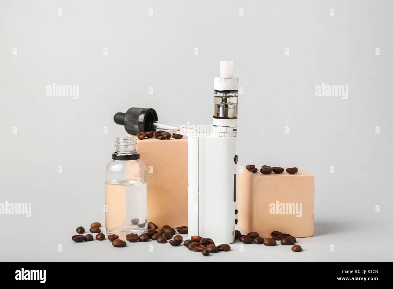Modern vape mod, oil and coffee beans on grey background Stock Photo ...