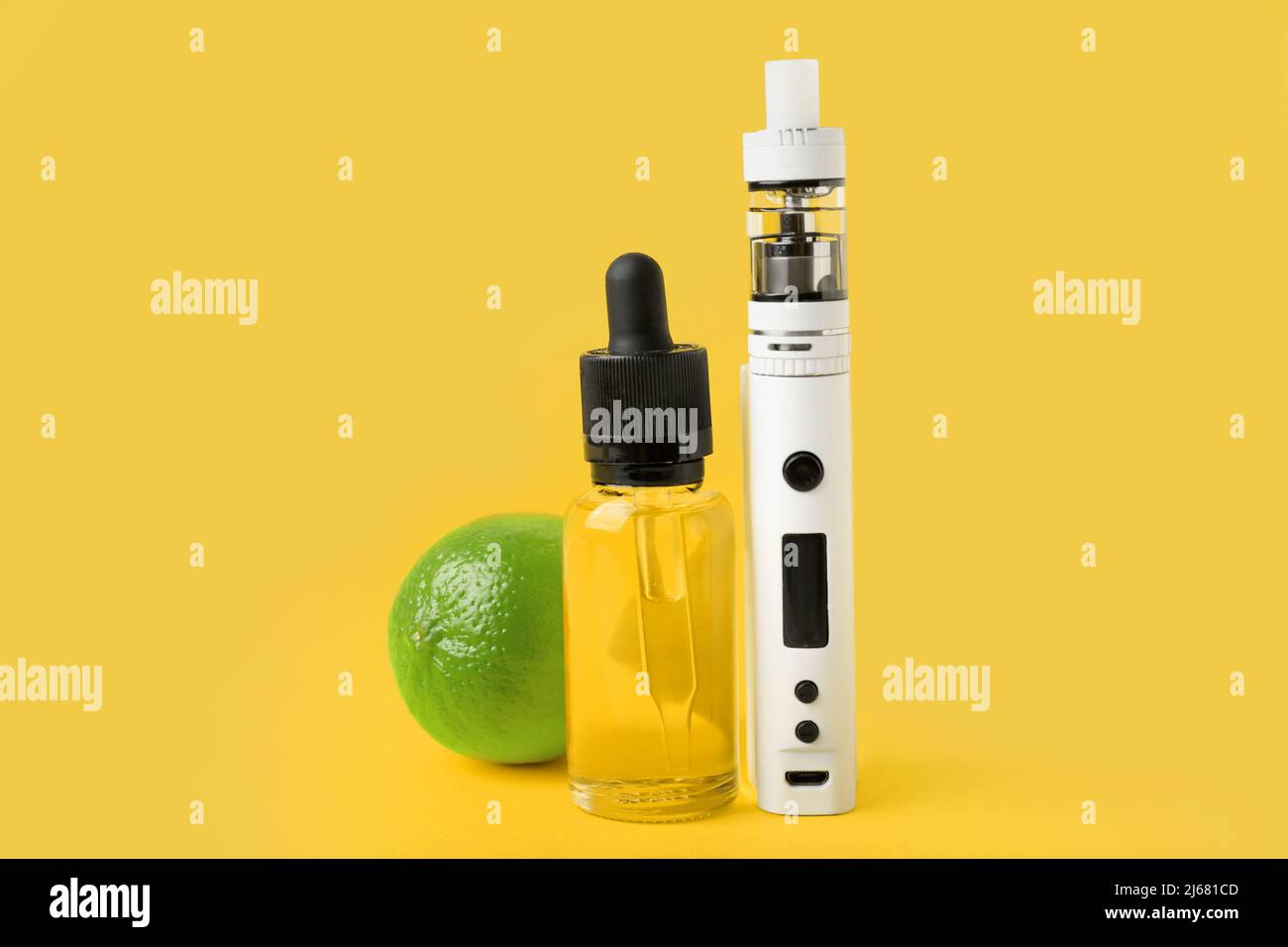 Modern vape mod, oil and lime on yellow background Stock Photo - Alamy