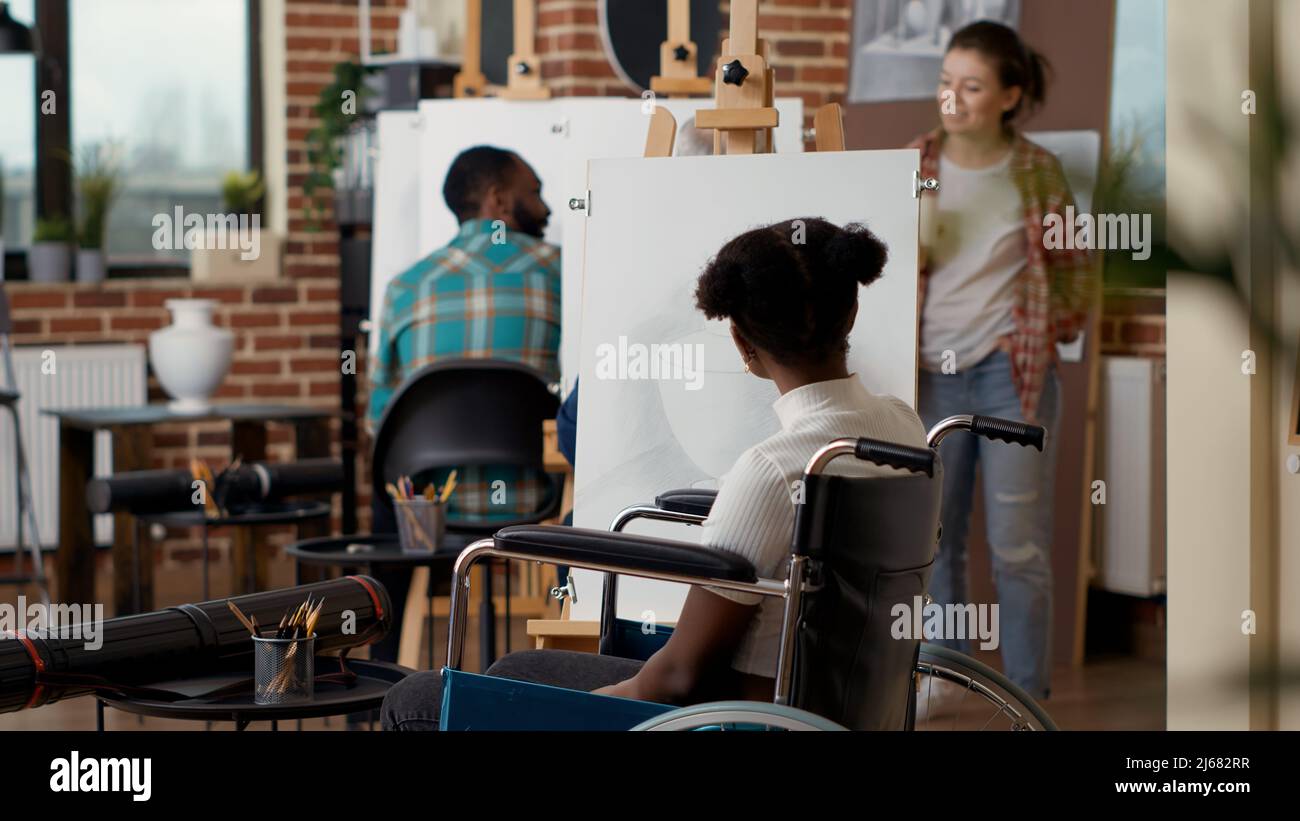 African american woman with disability attending art class program to ...