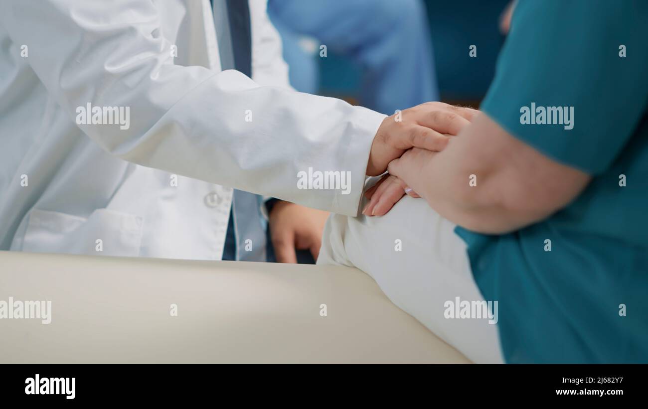 Male doctor comforting senior patient in medical cabinet after sharing ...