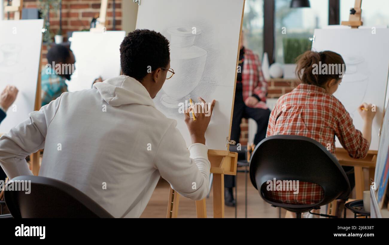 African american student drawing contemporary sketch in art class ...