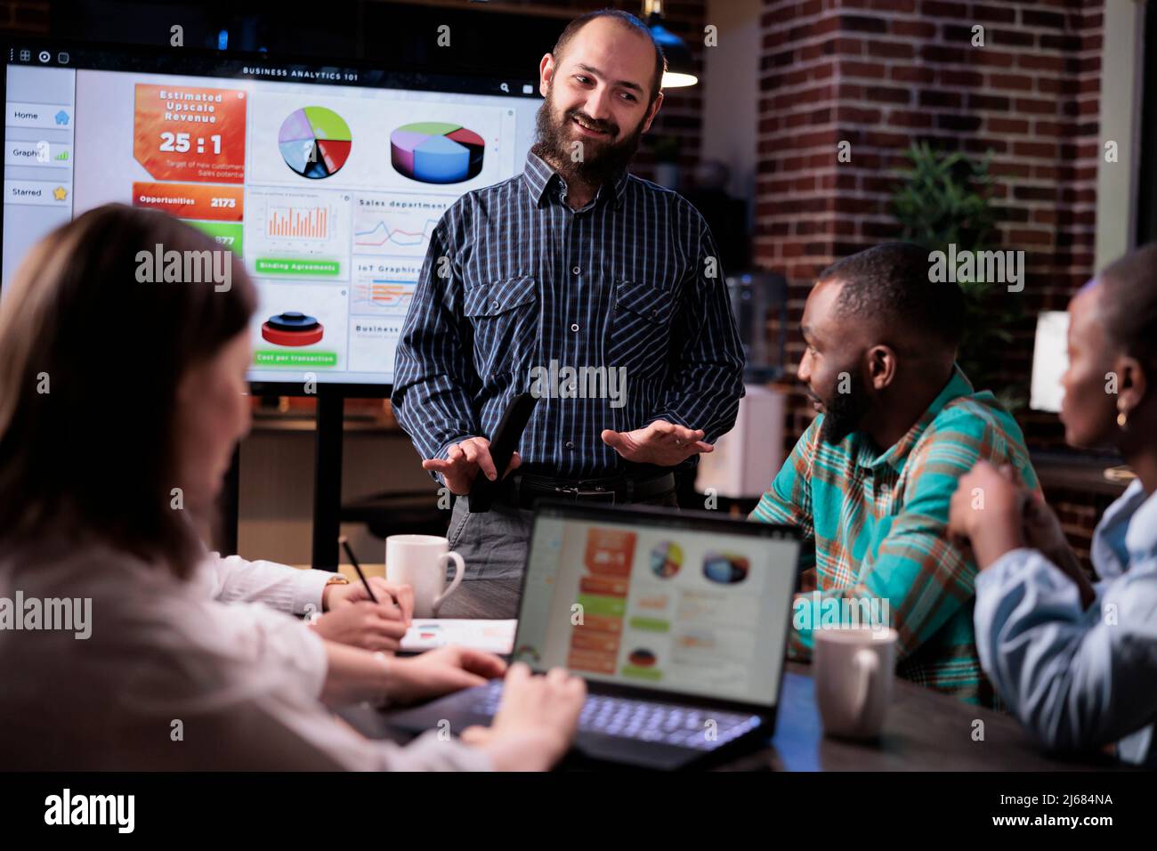 Startup employee happy with company sales results smiling at coworkers ...