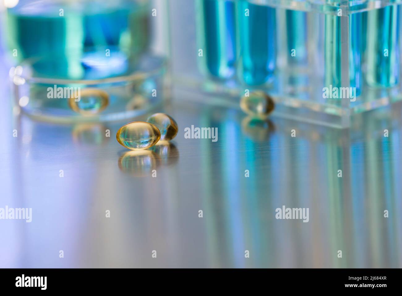 Soft capsules scattered on a medical research bench - stock photo Stock ...