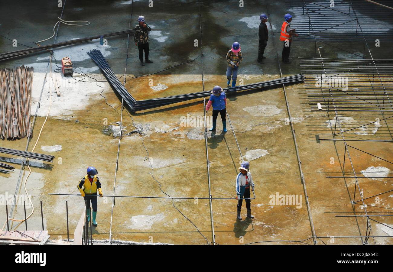 DANZHOU, CHINA - APRIL 27, 2022 - Workers work at the construction site ...
