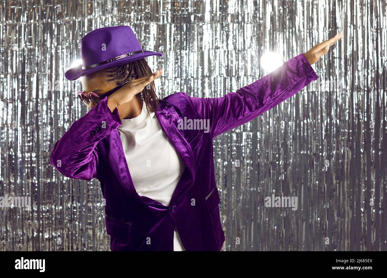 Black woman in disco suit dab dancing Stock Photo - Alamy