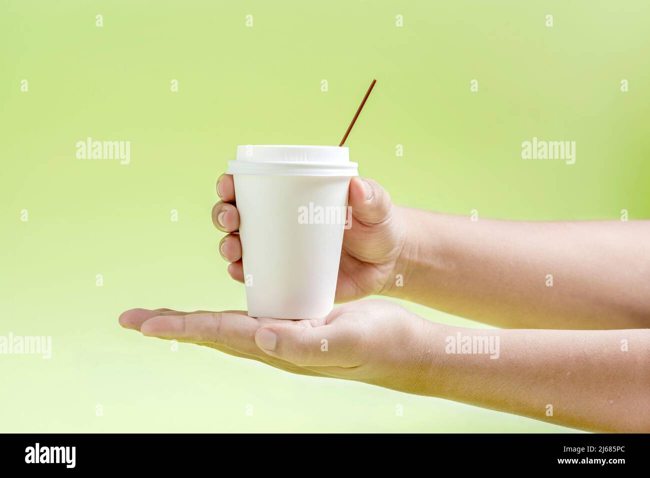 Human hand holding a white plastic cup with colored background Stock ...
