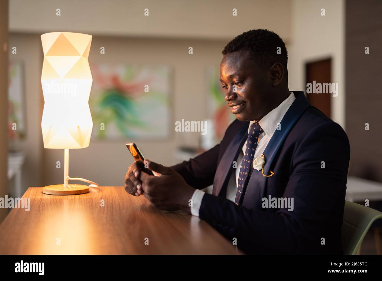 Portrait of handsome young African man in office at night Stock Photo ...