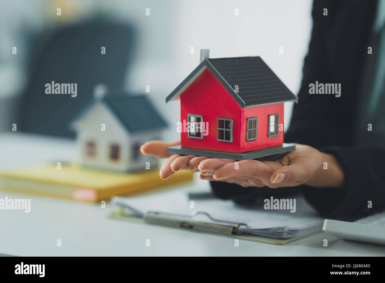 Close up Business woman or Real Estate agent giving house after signing ...