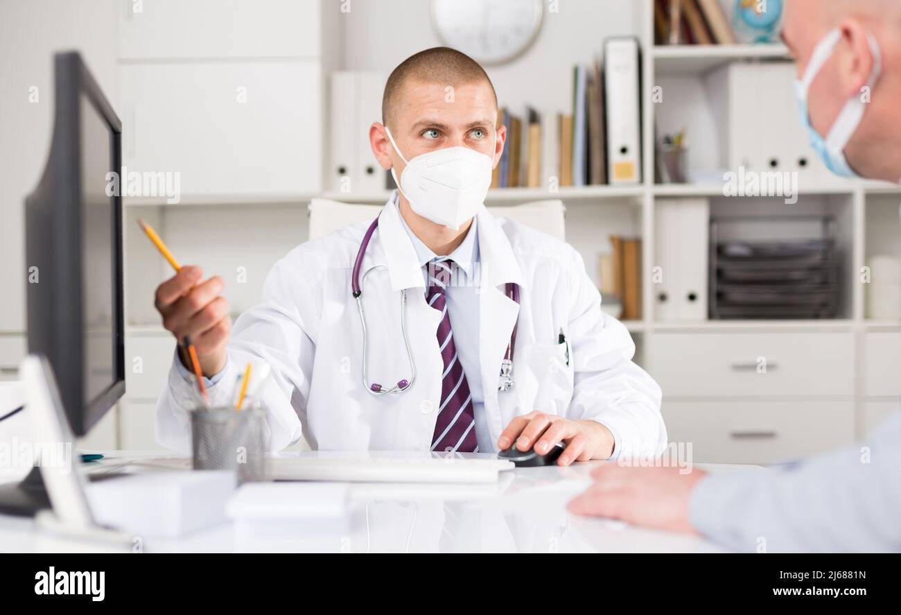 Doctor advising male patient hi-res stock photography and images - Alamy