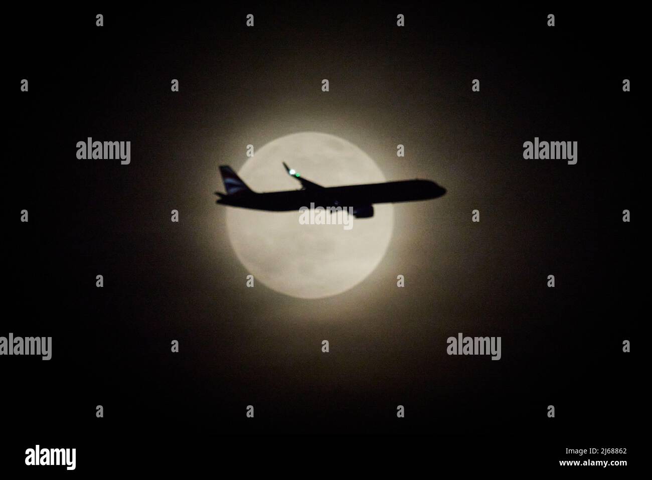 British Airways plane passing the moon Stock Photo - Alamy
