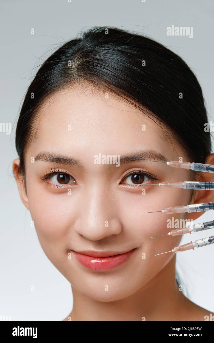 Do facial injections of young women Stock Photo - Alamy