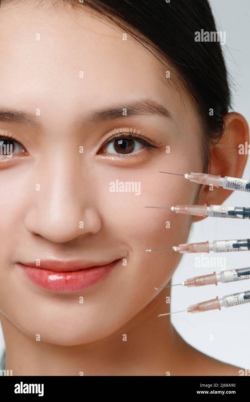Do facial injections of young women Stock Photo - Alamy
