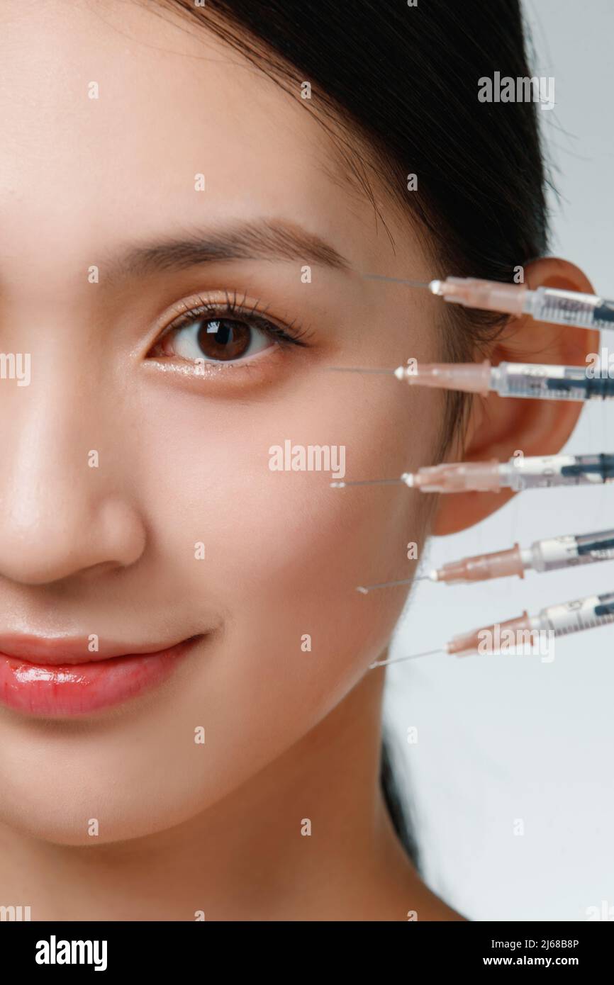 Do facial injections of young women Stock Photo - Alamy