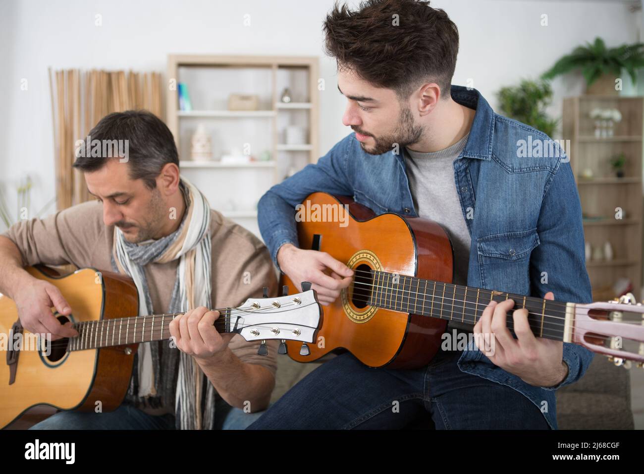 two men jamming with guitars Stock Photo - Alamy
