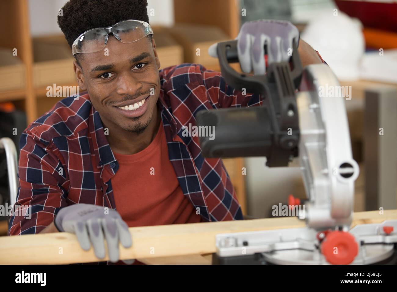Happy male worker cutting hi-res stock photography and images - Alamy
