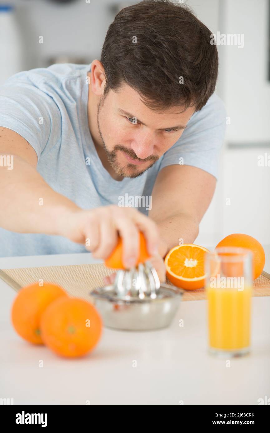 Man making orange juice close hi-res stock photography and images - Alamy