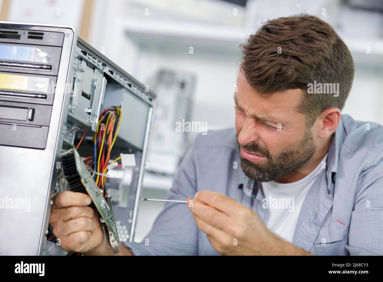 computer engineer working on broken console in his office Stock Photo ...