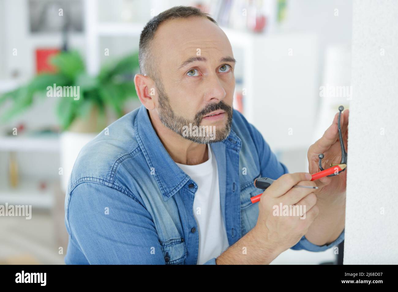 Man doing diy hi-res stock photography and images - Alamy