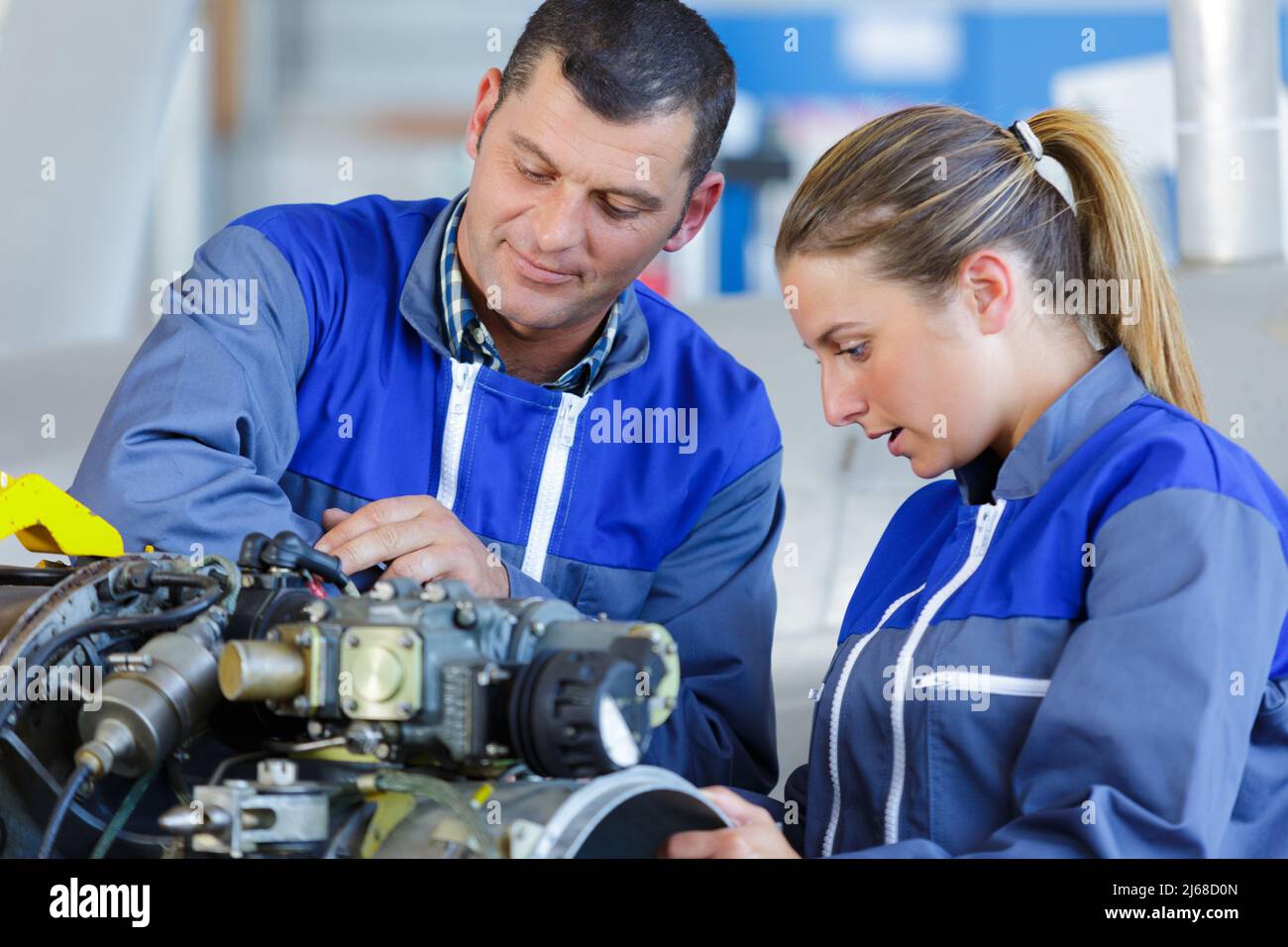 two mechanics working in workshop Stock Photo - Alamy