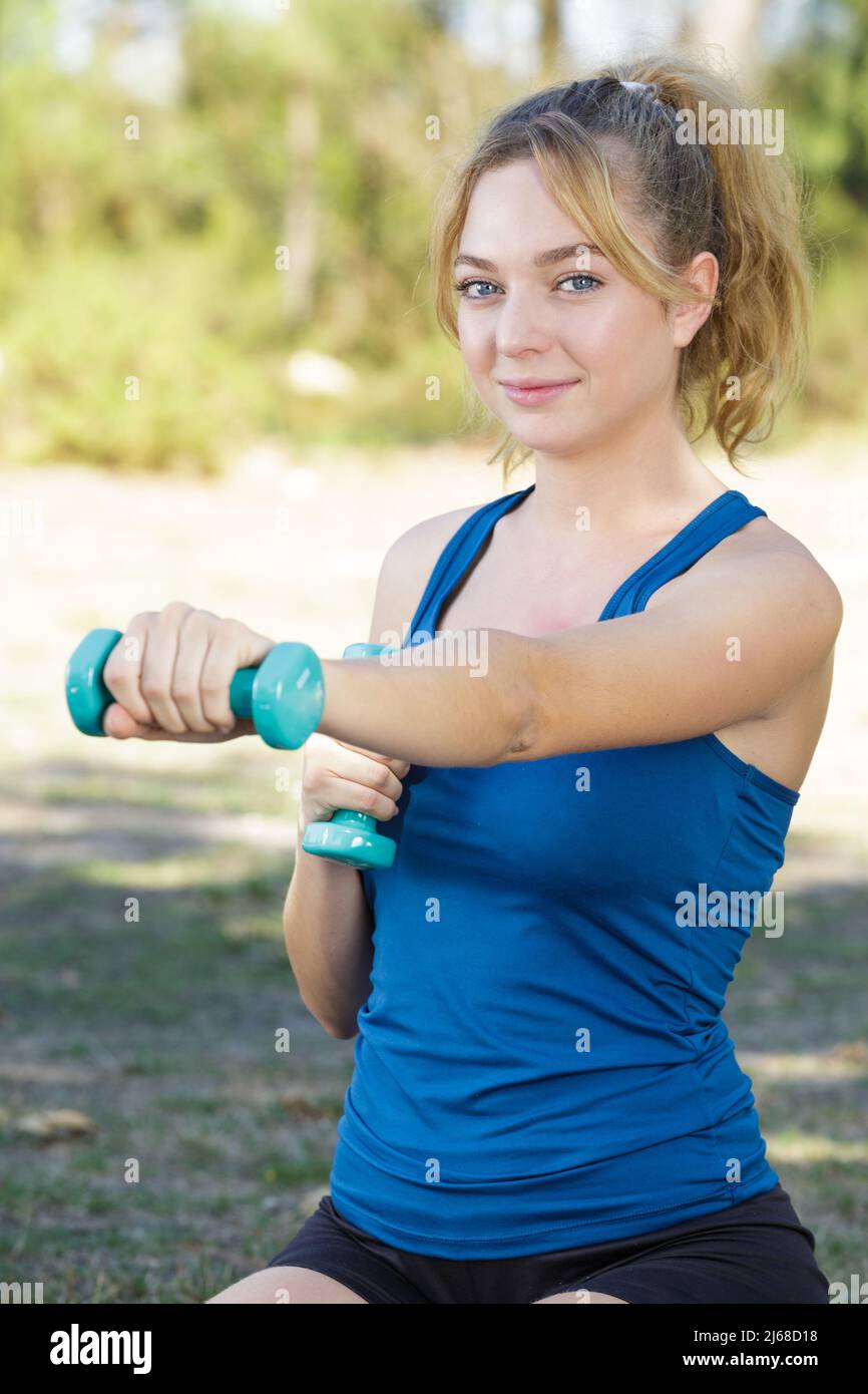 beautiful sporty girl workout with dumbbells outdoors Stock Photo - Alamy