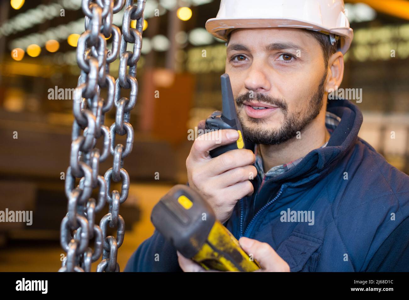 workman talking on walkie talkie Stock Photo - Alamy