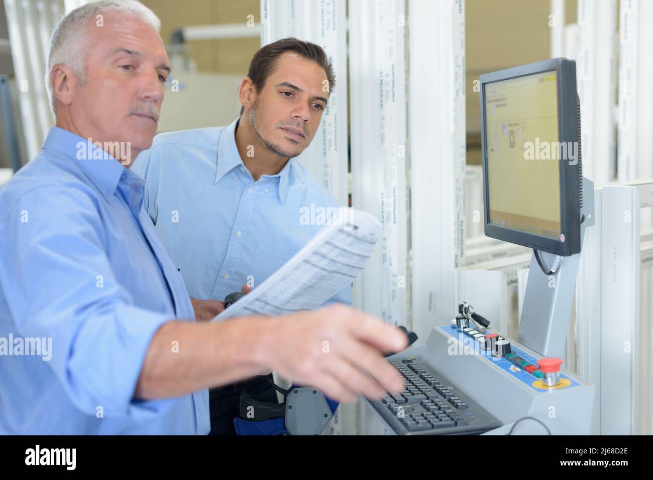 Two engineers looking at computer hi-res stock photography and images ...