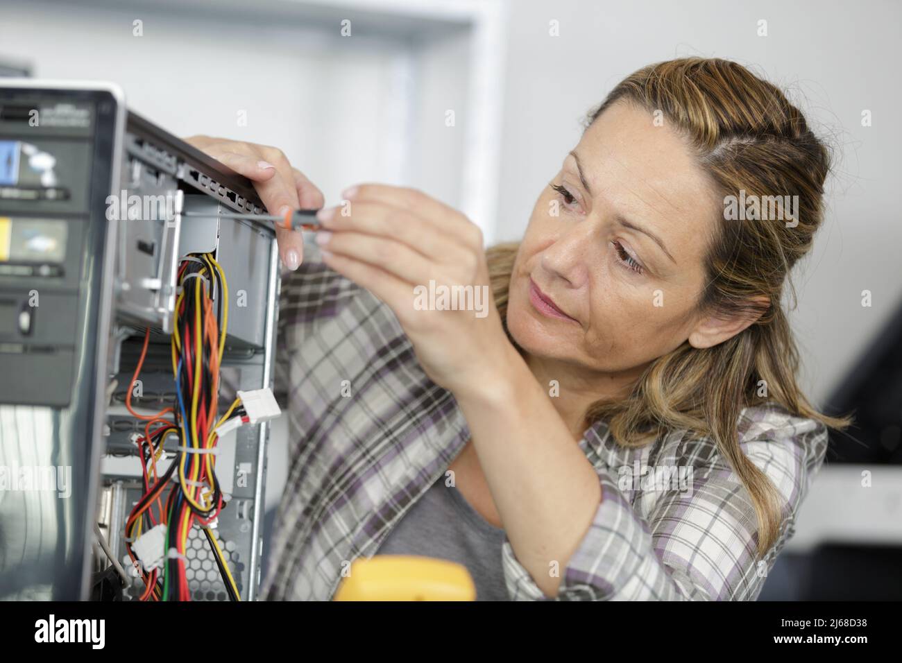 mature woman fixing a computer Stock Photo - Alamy