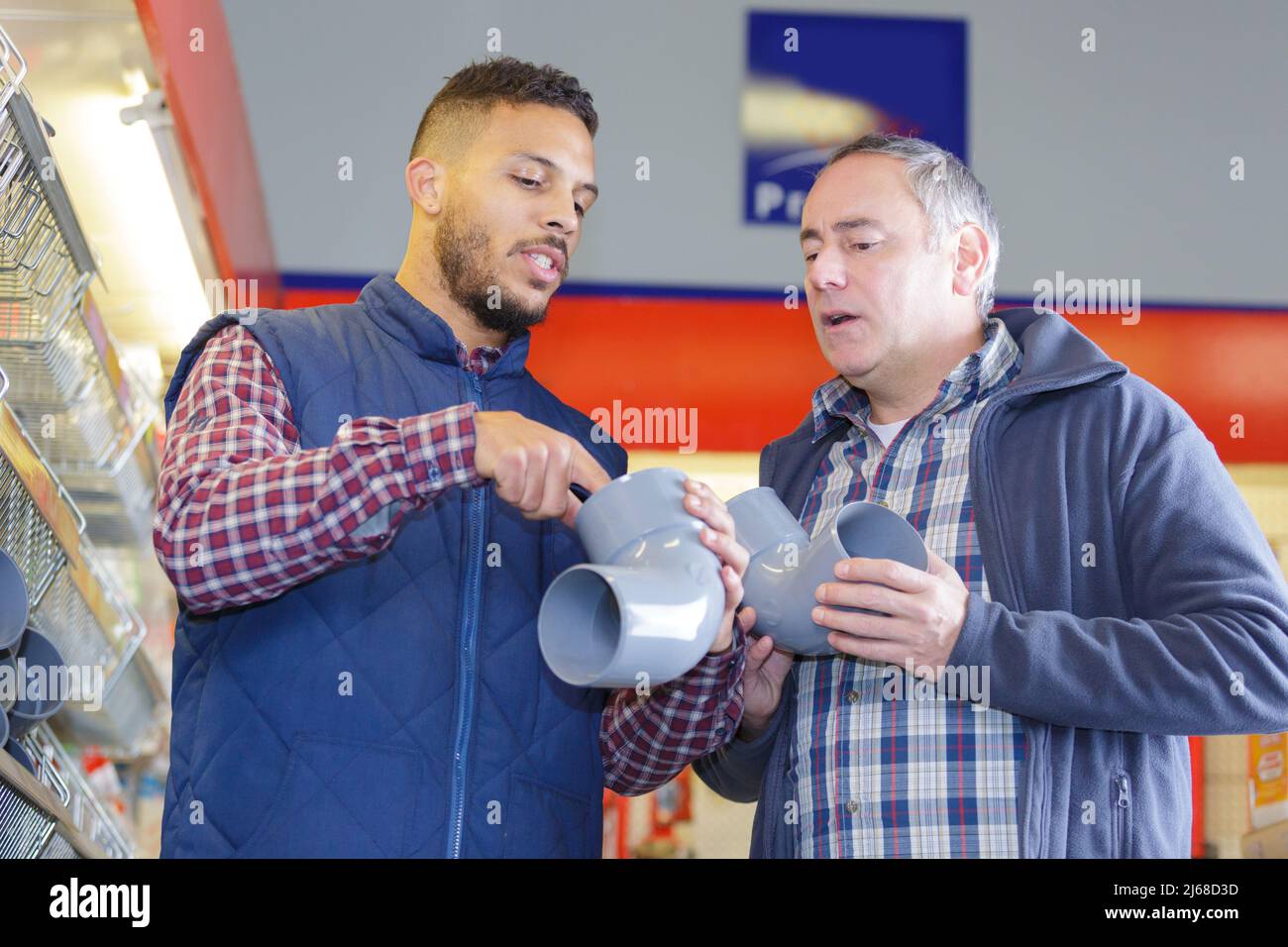 workshop owner with customer Stock Photo - Alamy
