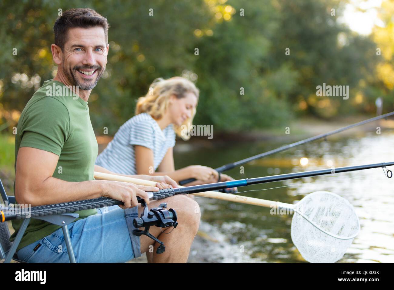 couple fishing in the river during summer vacation Stock Photo - Alamy