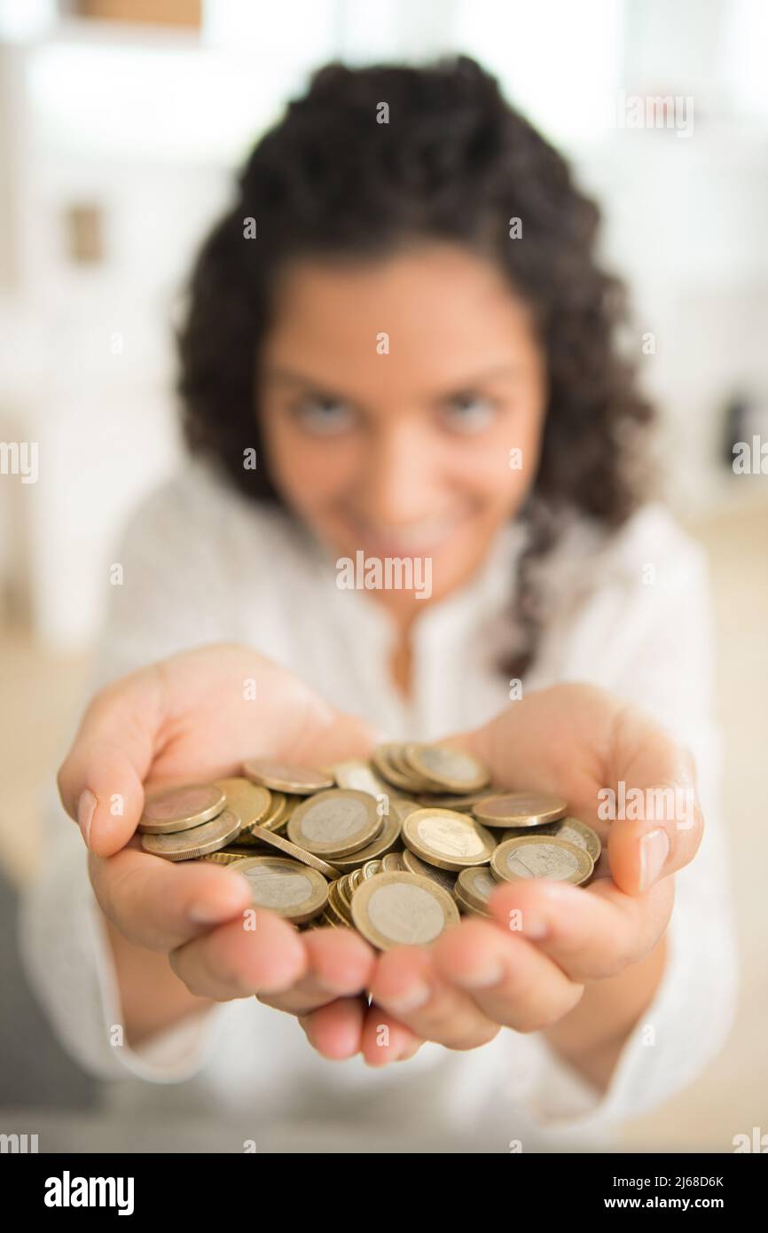 woman holding coins in hand Stock Photo - Alamy