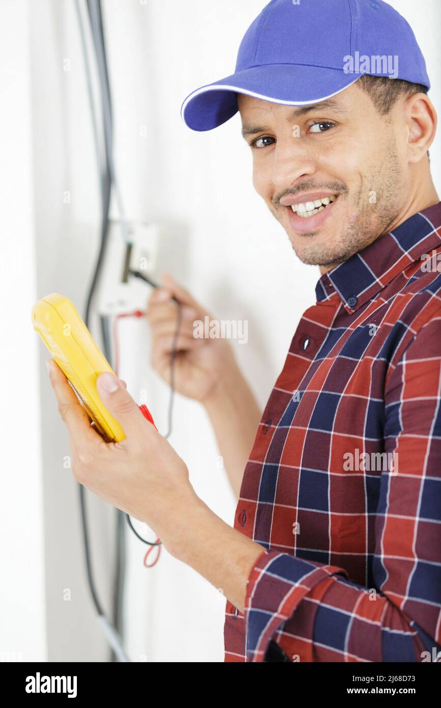 happy electrician installer with a tool in his hands Stock Photo - Alamy