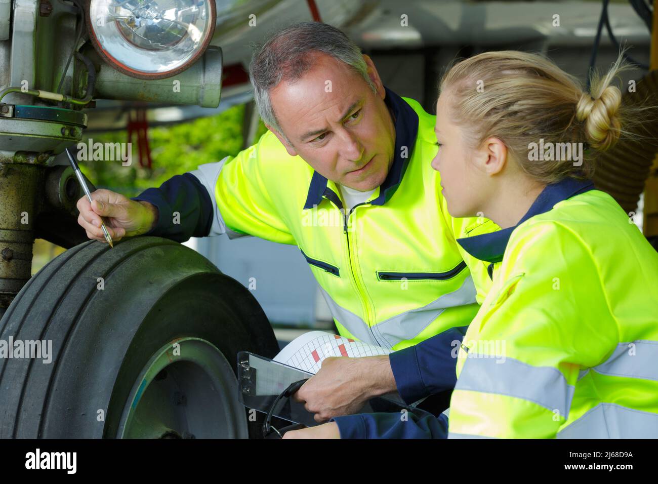 airplane service crew repairing plane in hangar Stock Photo - Alamy