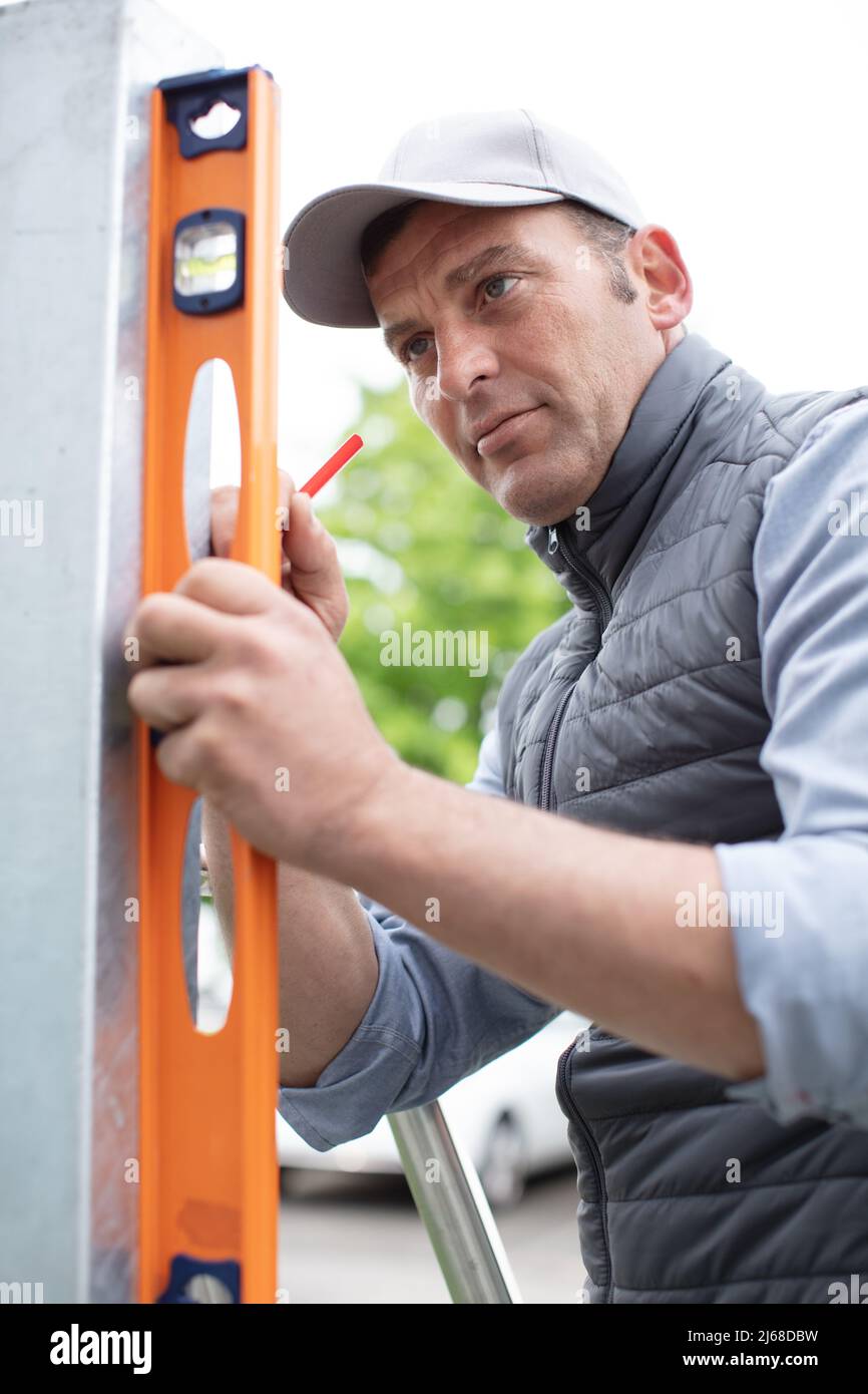 man measures the level outdoors Stock Photo - Alamy