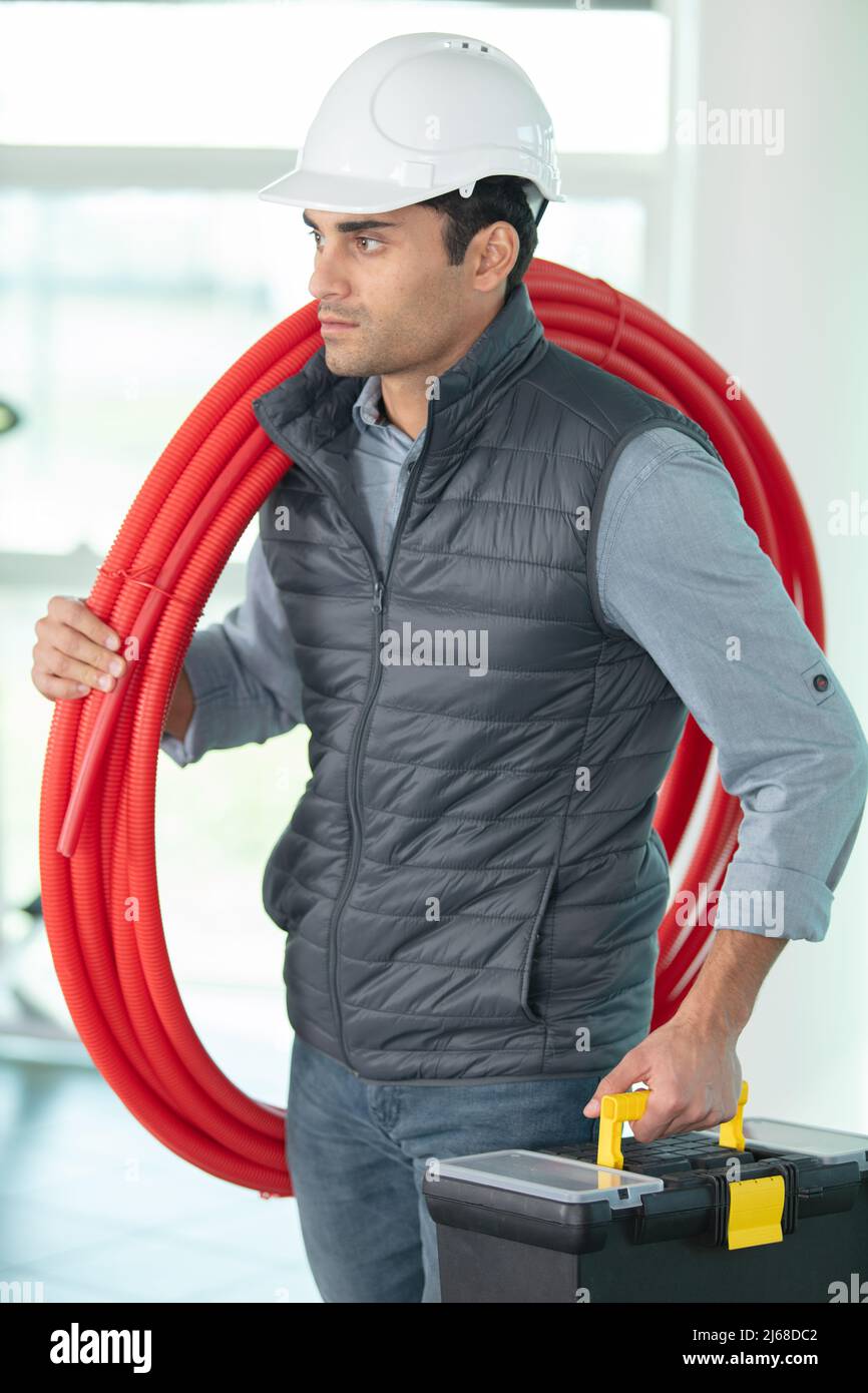 Construction worker carrying pipes hi-res stock photography and images ...