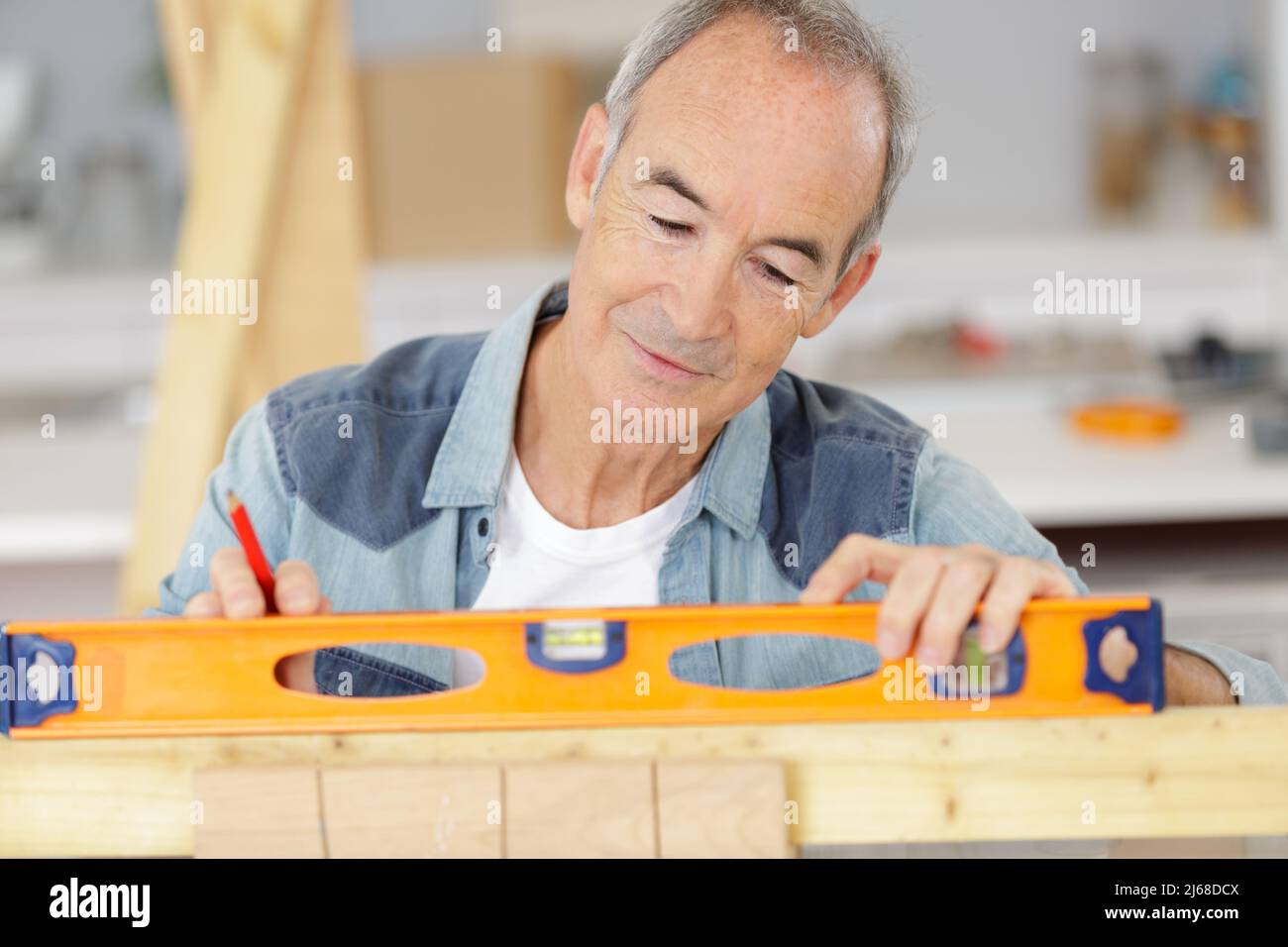 Senior man builder using measuring hi-res stock photography and images ...