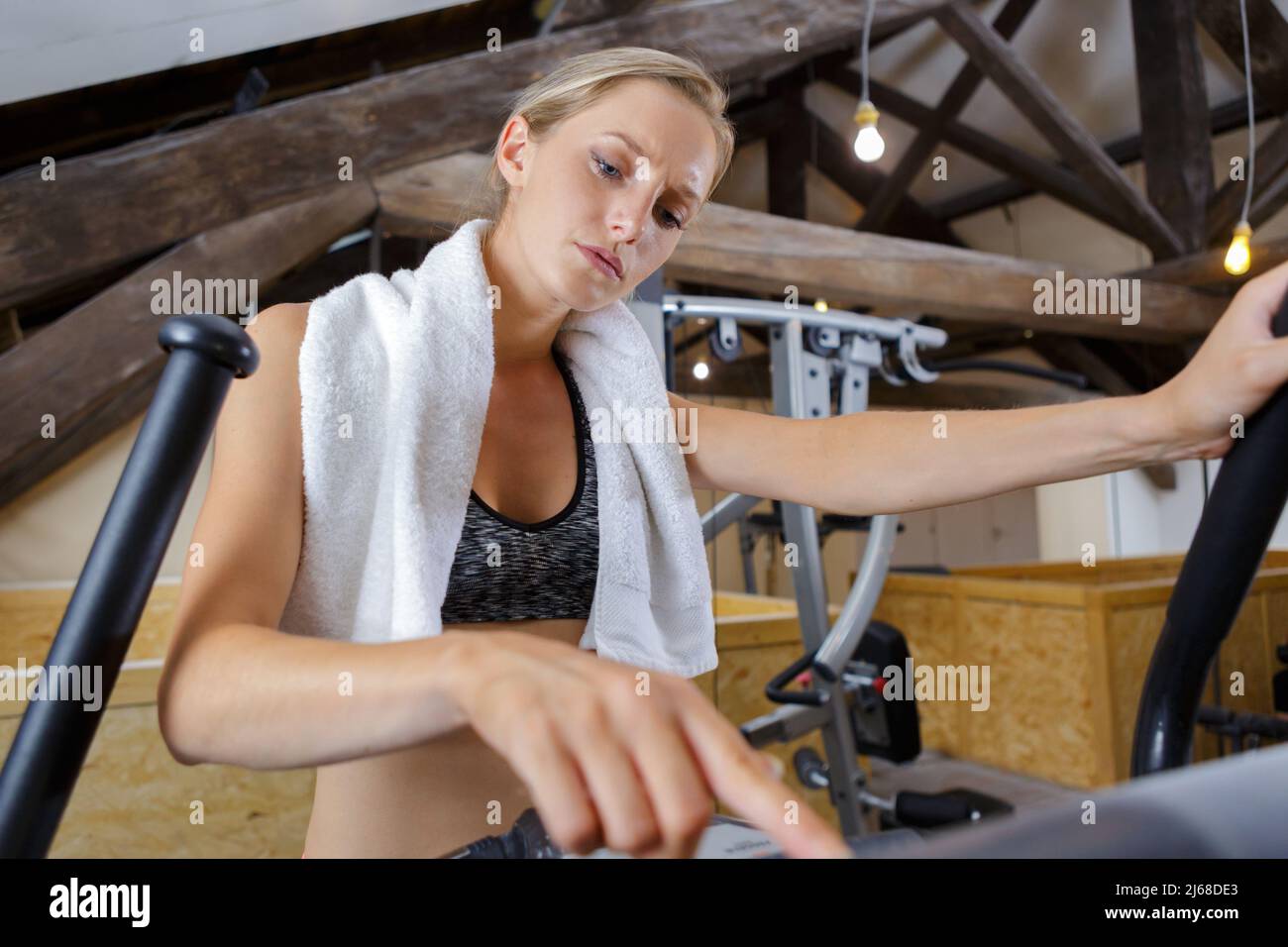 woman setting up exercise machine Stock Photo - Alamy