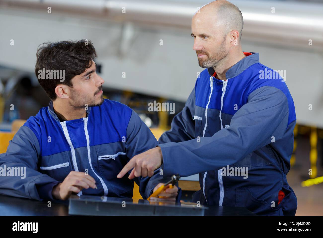 two men working at a factory Stock Photo - Alamy