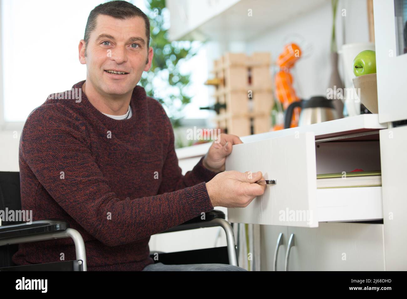 disabled man in wheelchair open drawer Stock Photo - Alamy