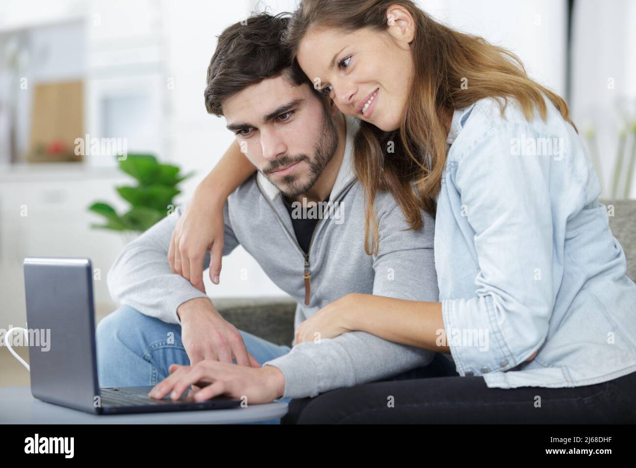 happy couple at home using a computer Stock Photo - Alamy