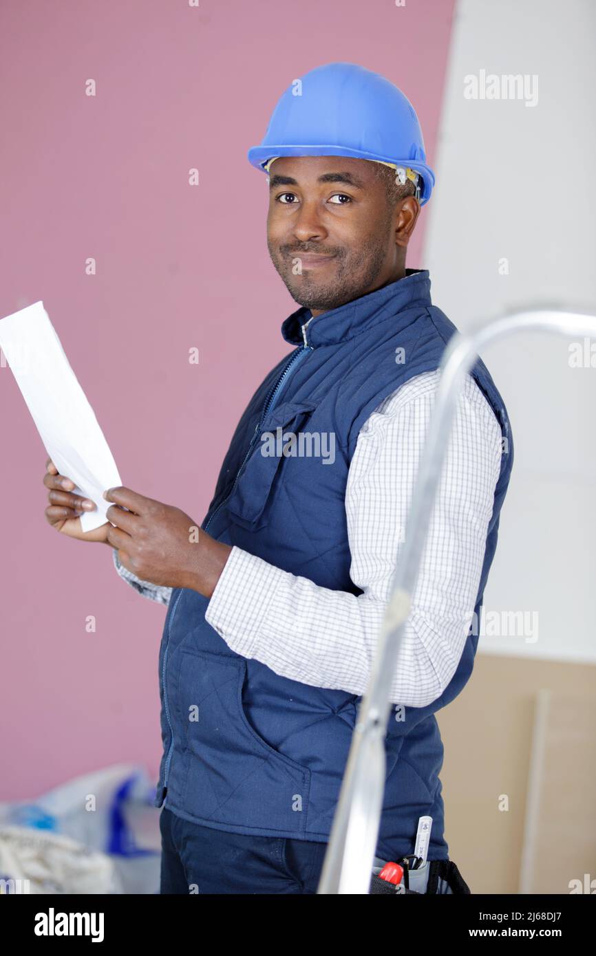 happy contractor worker preparing for redecoration Stock Photo - Alamy